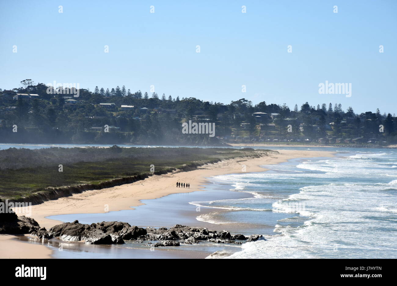 People walking on the beach at Blackfellows Point. Potato Point is a ...
