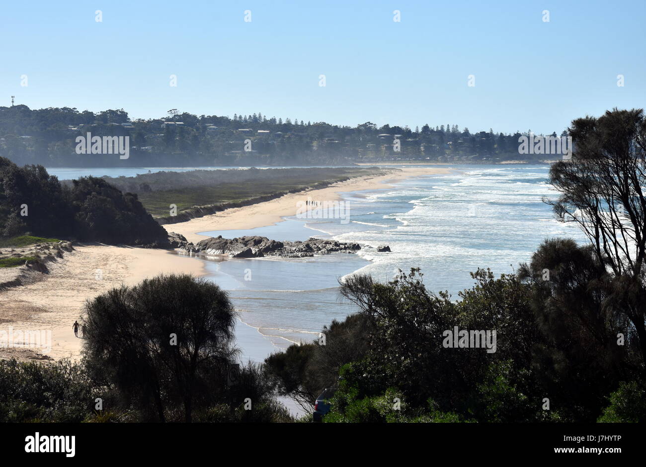 People walking on the beach at Blackfellows Point. Potato Point is a ...