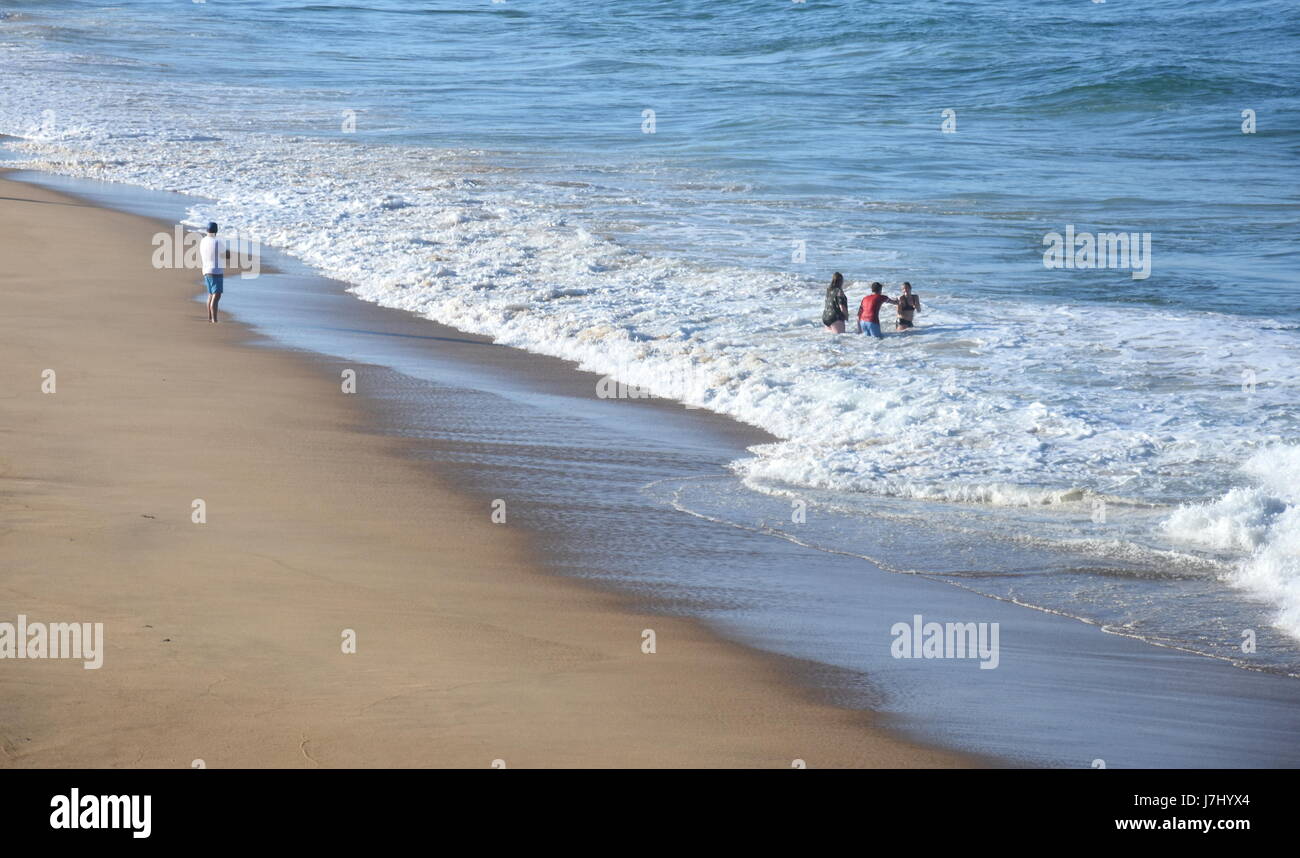 People relaxing swimming and sun bathing on the beach Stock Photo - Alamy