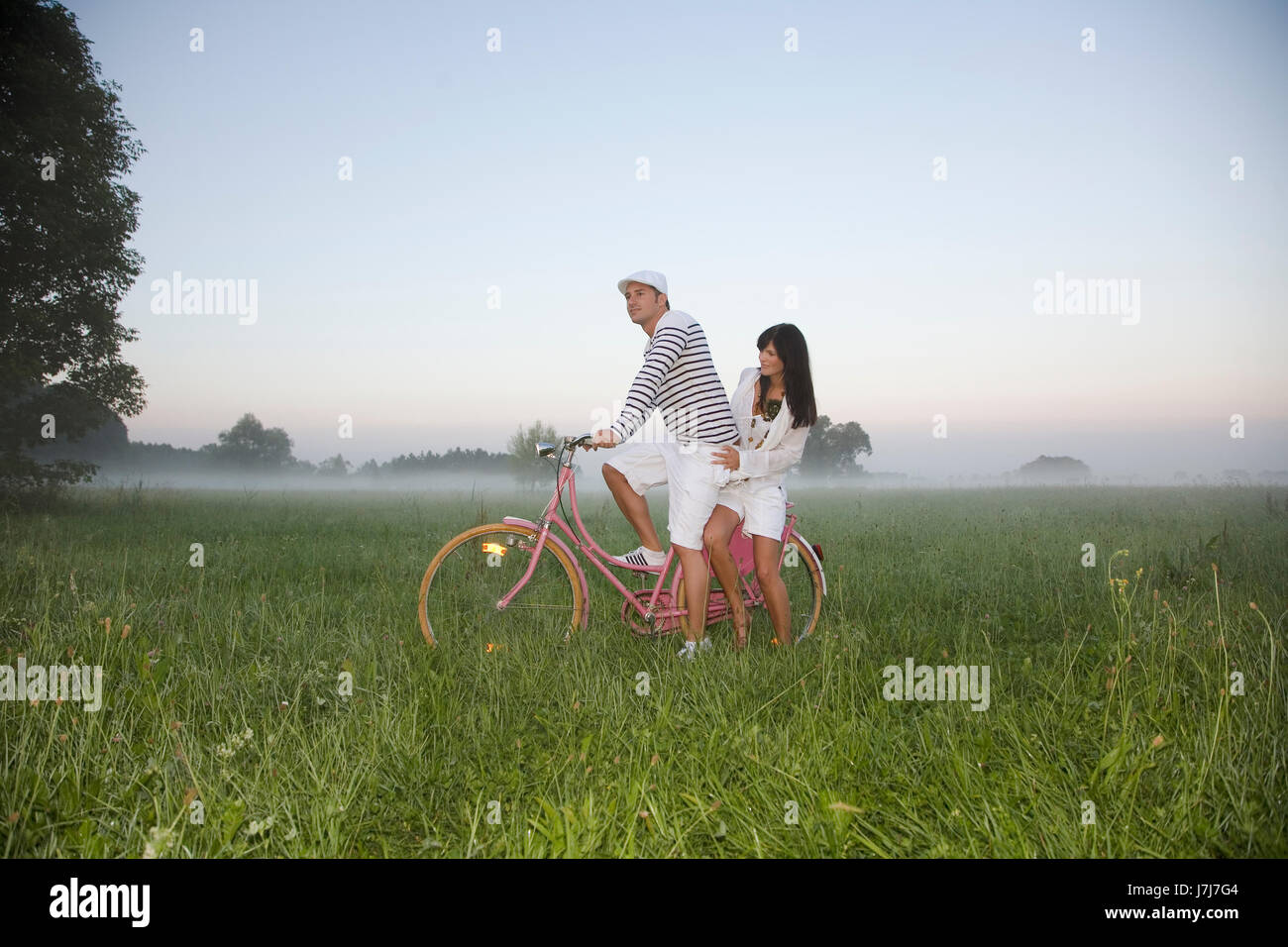 couple on bike Stock Photo - Alamy
