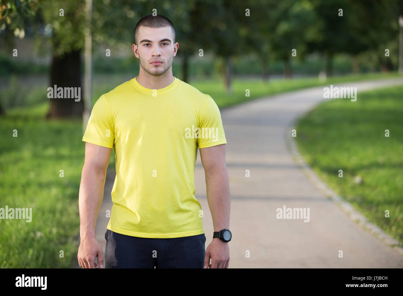 Fitness man stretching arm shoulder before outdoor workout. Sporty male ...