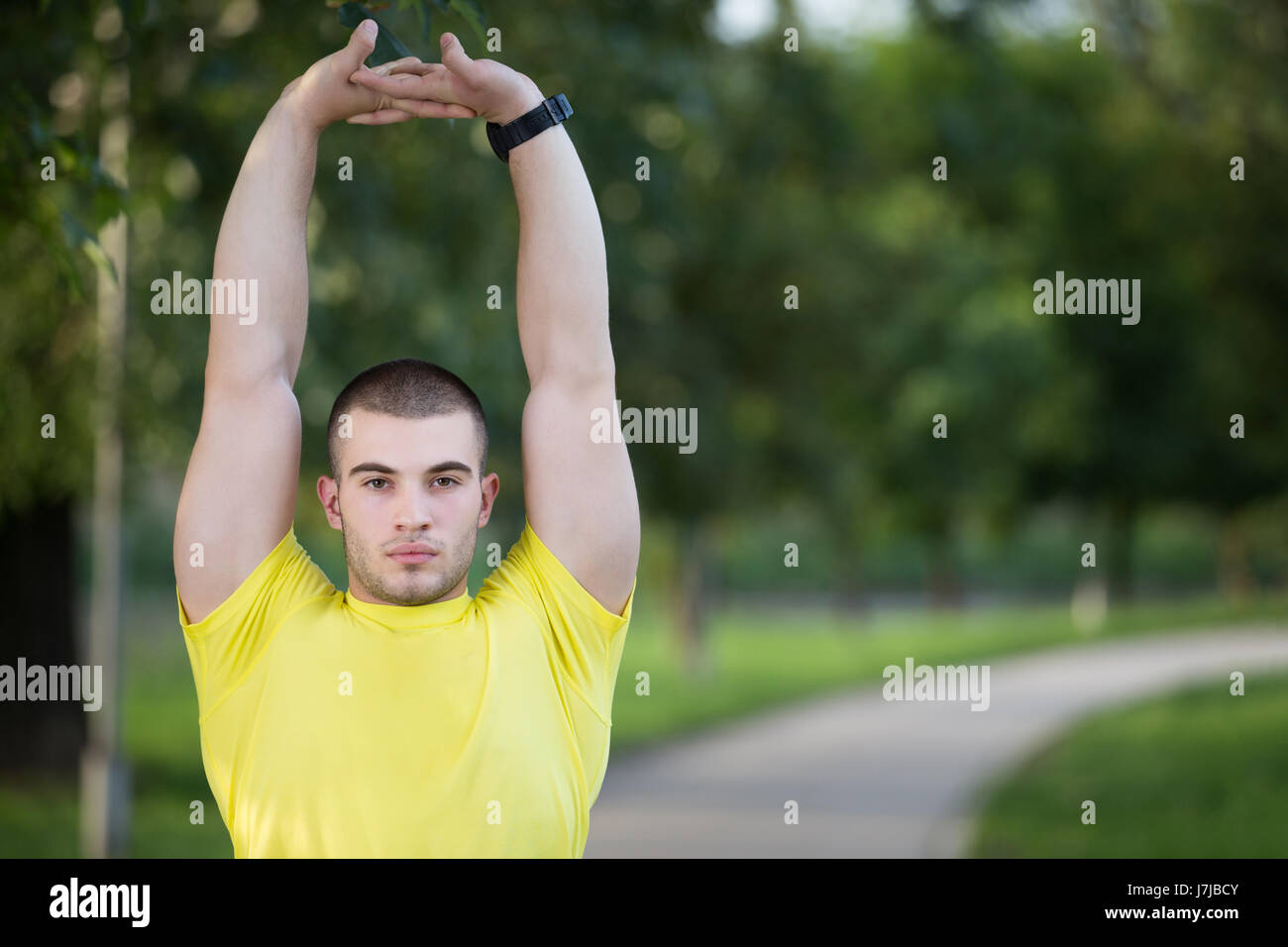 Fitness man stretching arm shoulder before outdoor workout. Sporty male ...