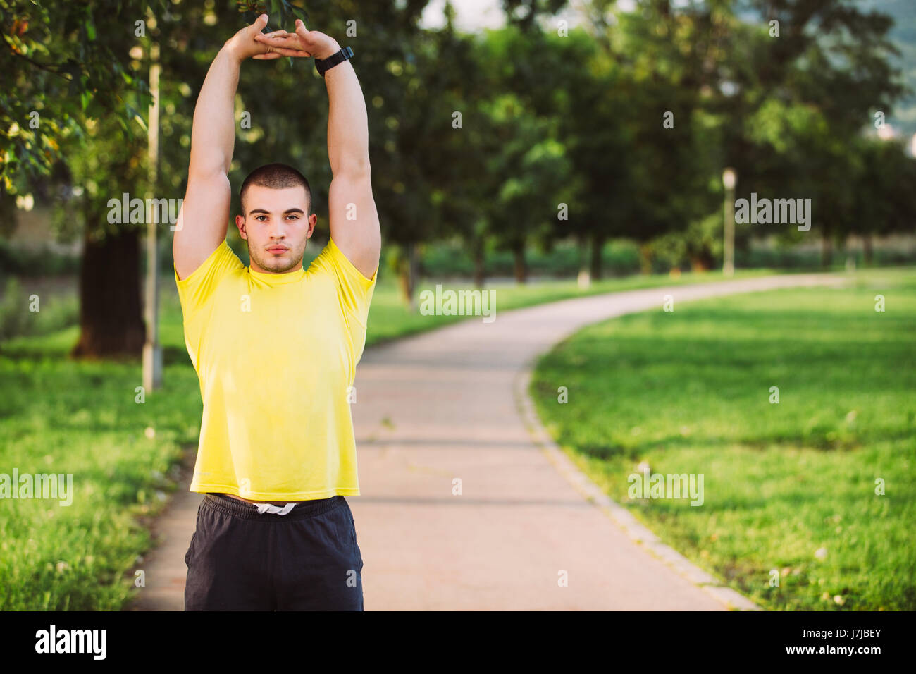 Fitness man stretching arm shoulder before outdoor workout. Sporty male ...