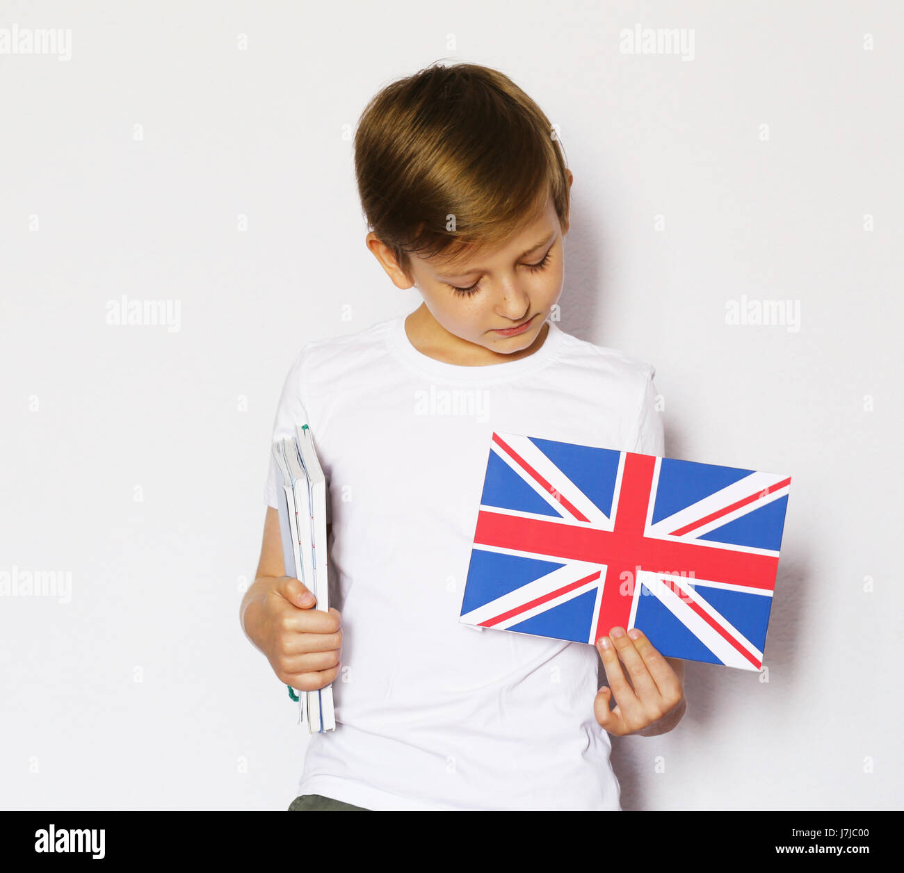 Cute blonde boy in casual clothes posing with british flag Stock Photo ...
