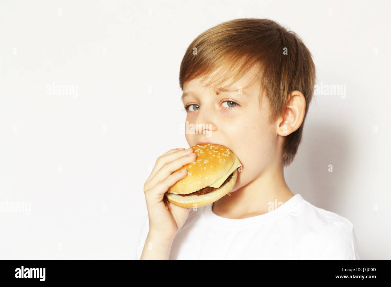 Boy eating burger party hi-res stock photography and images - Alamy