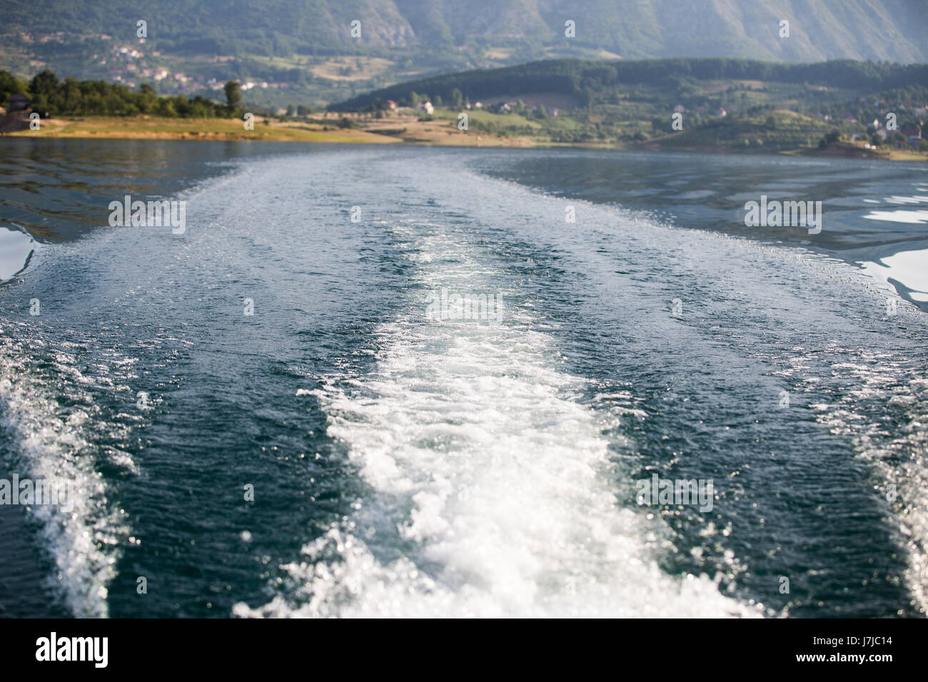 Stormy trace of motor boat crossing the emerald waters Stock Photo - Alamy