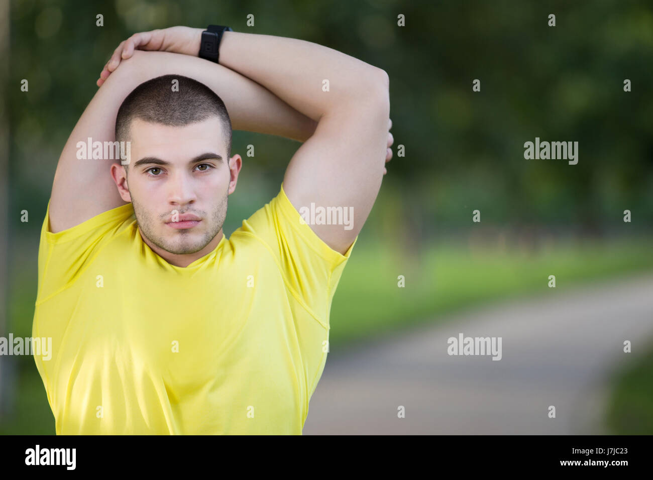 Fitness man stretching arm shoulder before outdoor workout. Sporty male ...