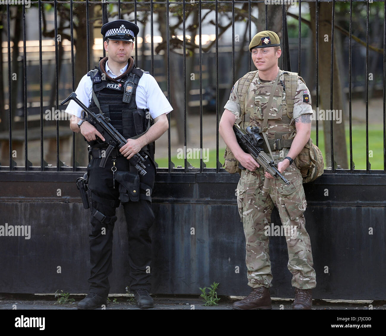 A soldiers joins police outside the Palace of Westminster, London, as ...
