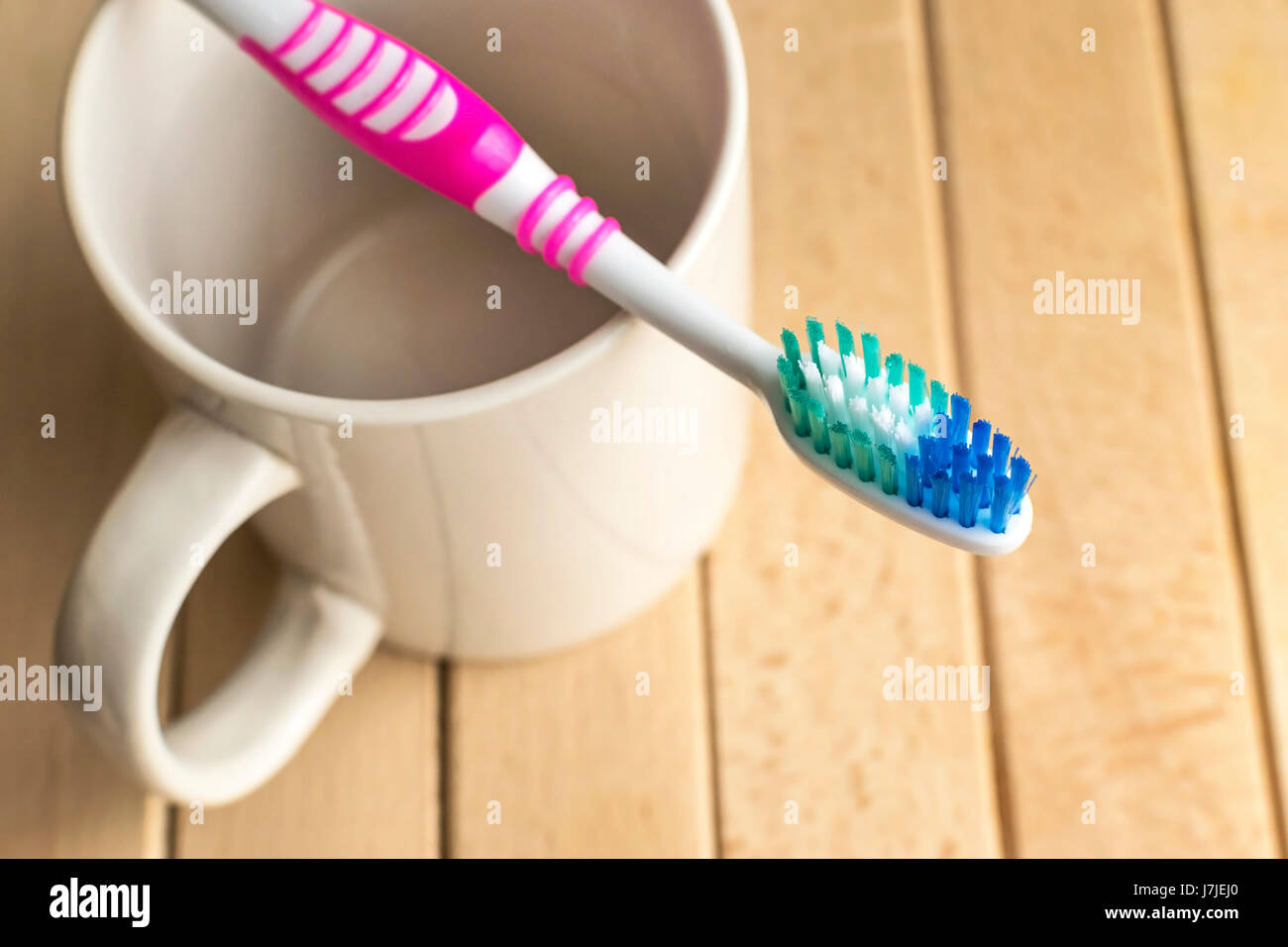 Toothbrush and toothpaste in cup hi-res stock photography and images ...