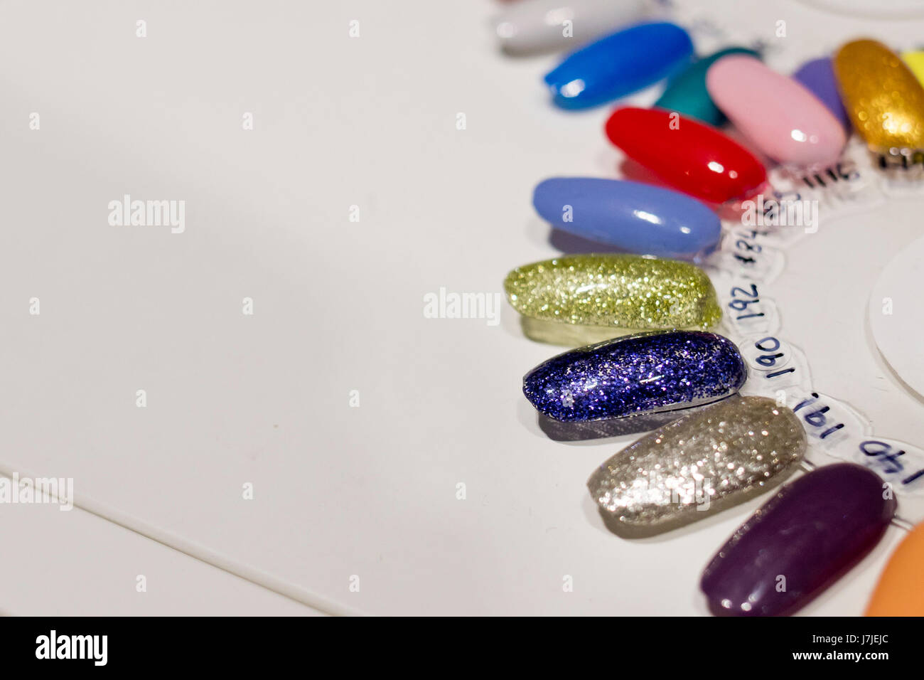 Samples of colorful fake nails on a white surface Stock Photo - Alamy