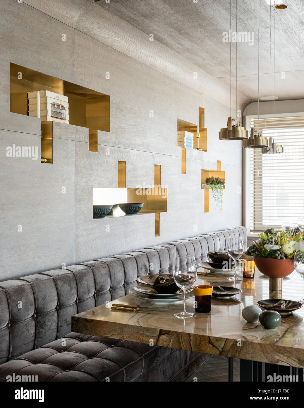 Laura Meroni brass hanging lights above custom made stonewood marble ...