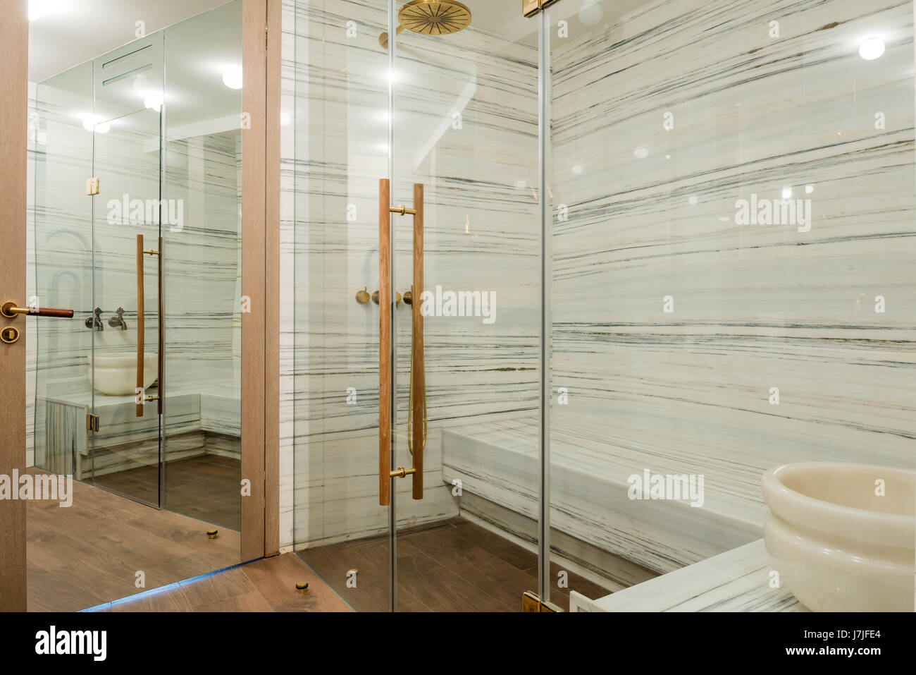 Marble lined spa with glass screen Stock Photo - Alamy