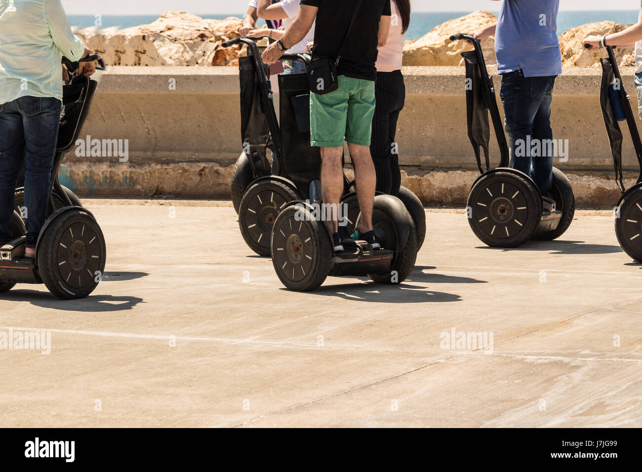 A group of people are riding on electric scooter Stock Photo - Alamy