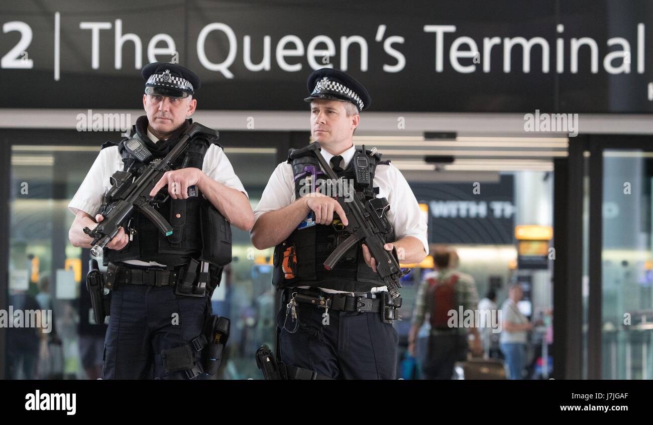 Police officers carry out patrol in terminal at heathrow airport hi-res ...