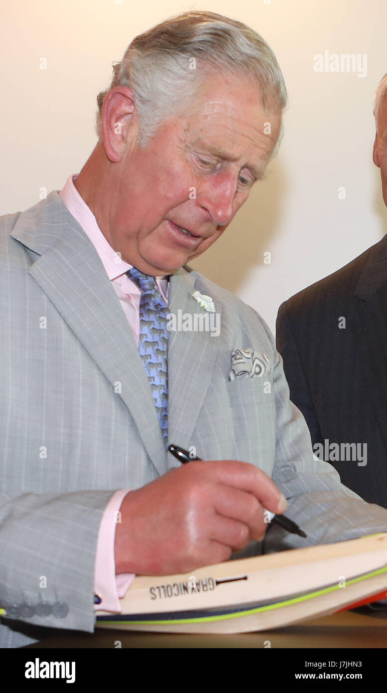 The Prince of Wales signs a cricket bat, which will be donated to ...