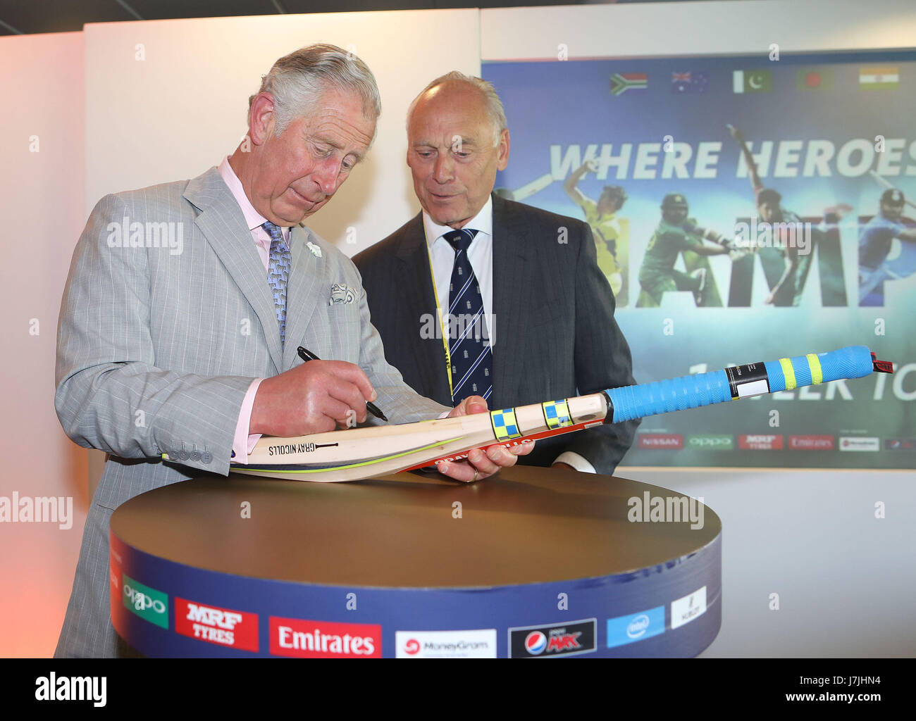 The Prince of Wales signs a cricket bat, which will be donated to ...
