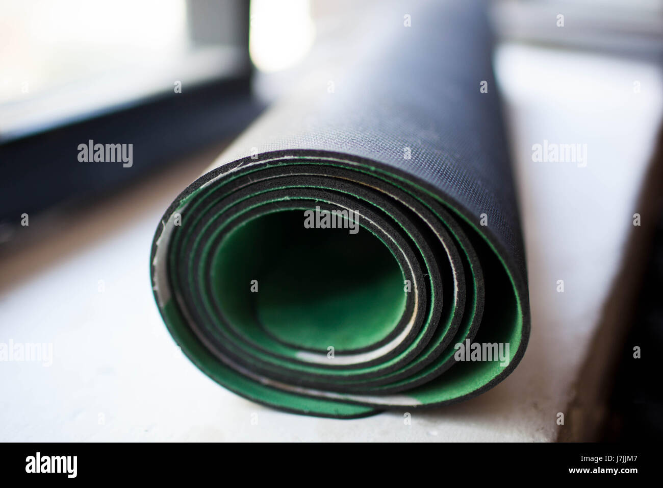 a rolled up yoga Mat Stock Photo - Alamy