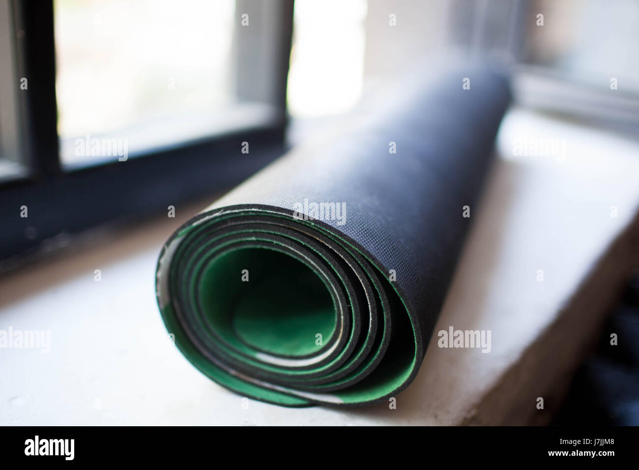 a rolled up yoga Mat Stock Photo - Alamy