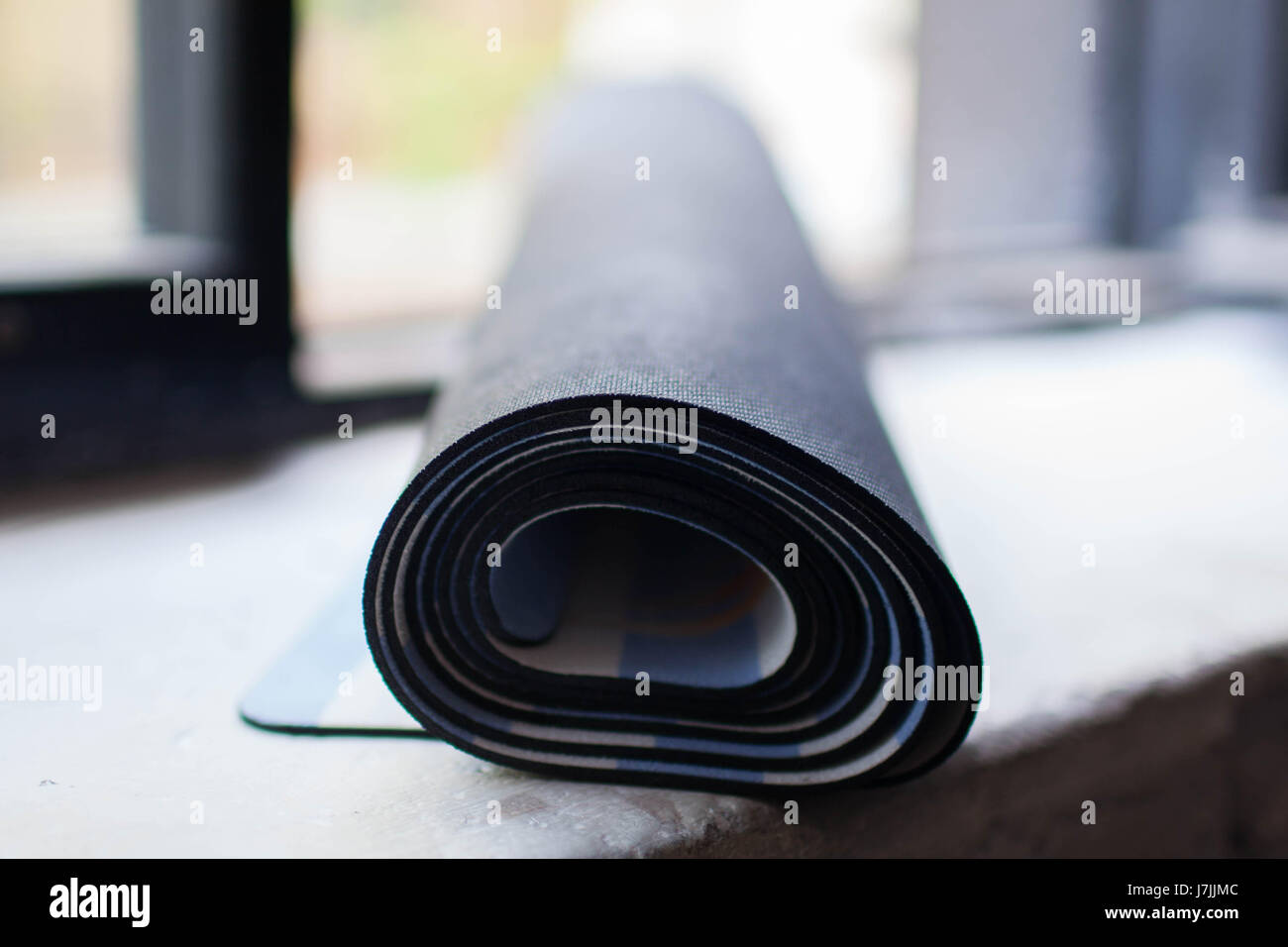 a rolled up yoga Mat Stock Photo - Alamy