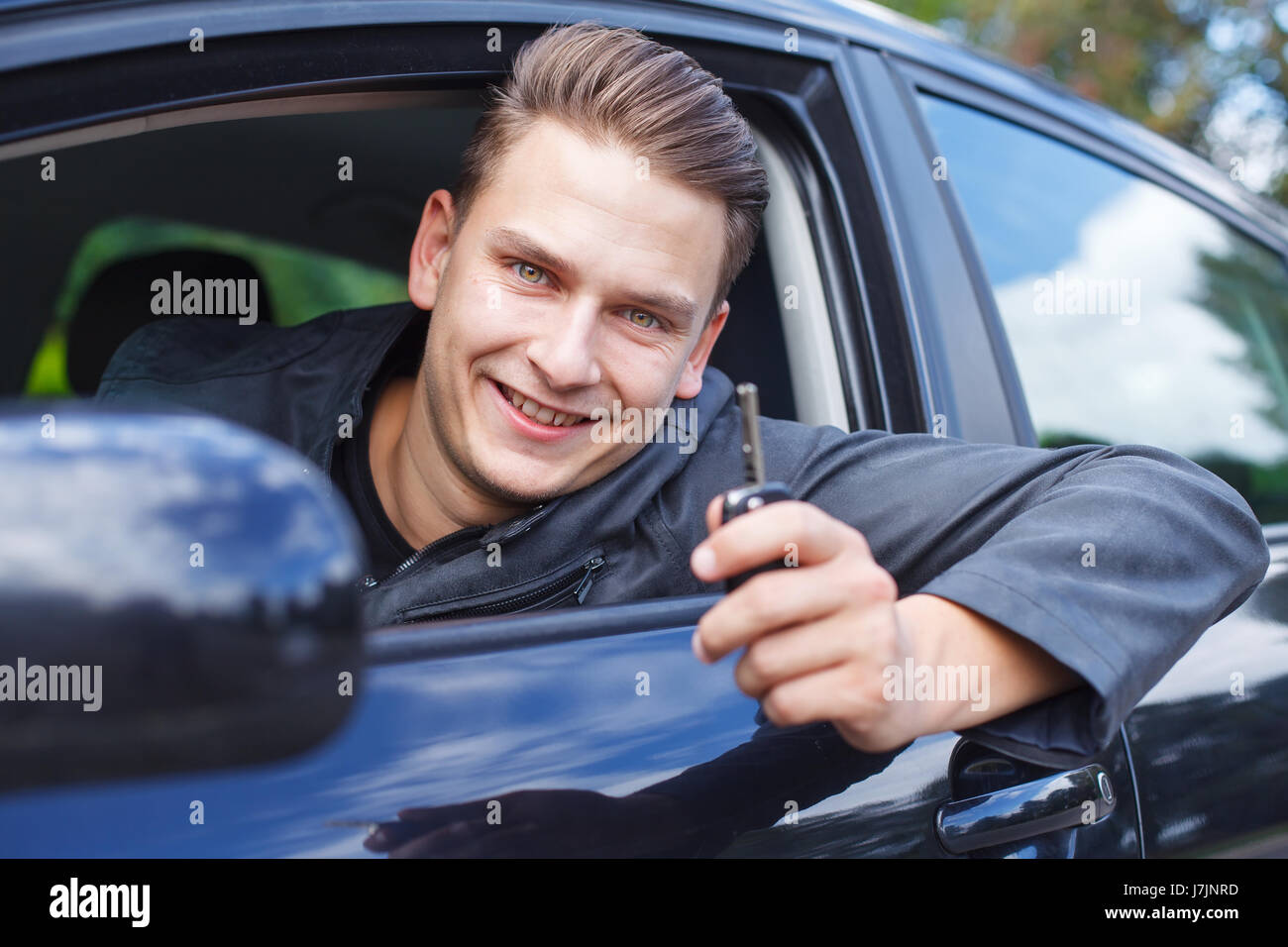 Portrait of a handsome young man driving a car Stock Photo - Alamy