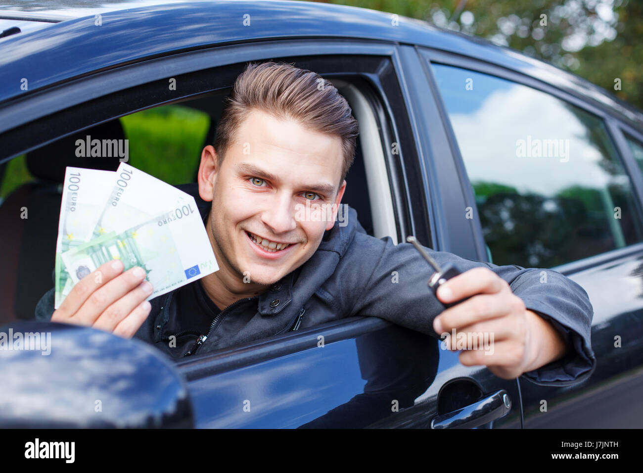 Portrait of a handsome young man driving a car Stock Photo - Alamy