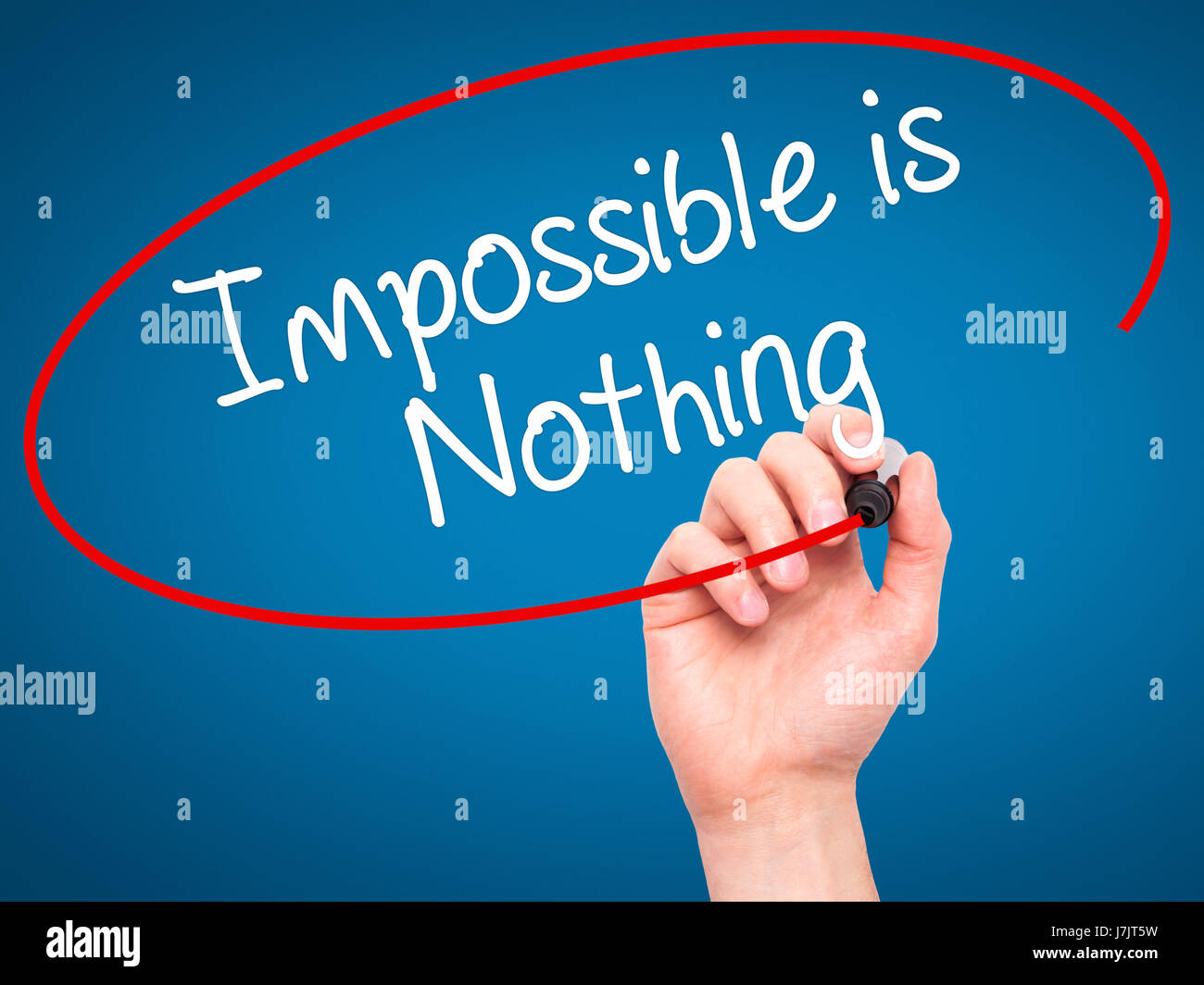 Man Hand writing Impossible is Nothing with black marker on visual ...