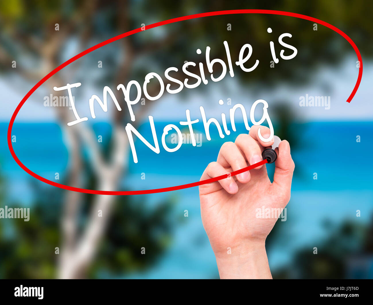 Man Hand writing Impossible is Nothing with black marker on visual ...