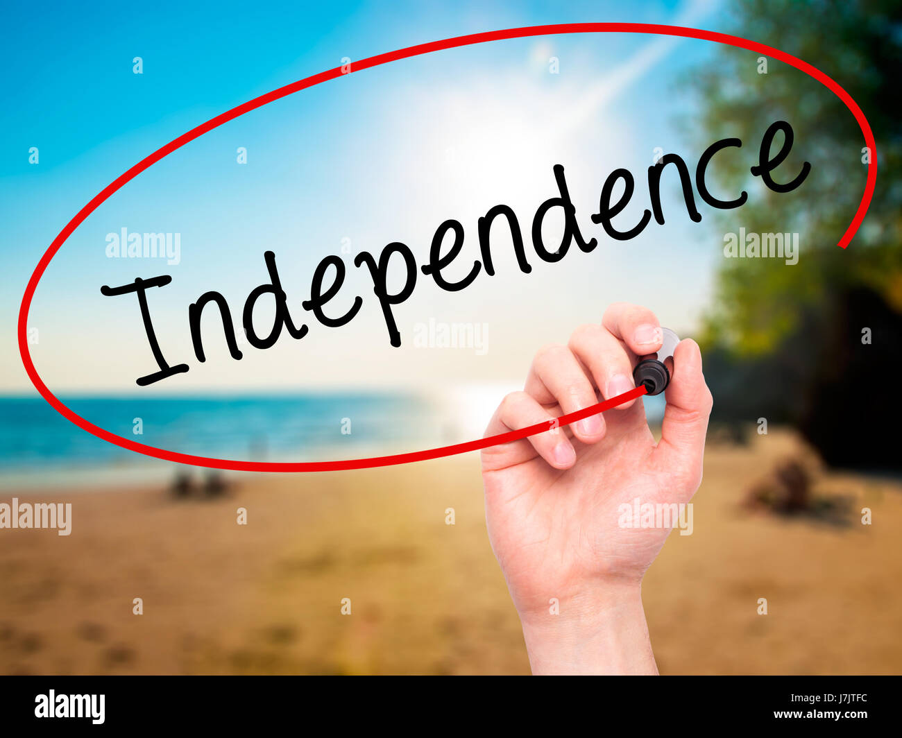 Man Hand writing Independence with black marker on visual screen ...