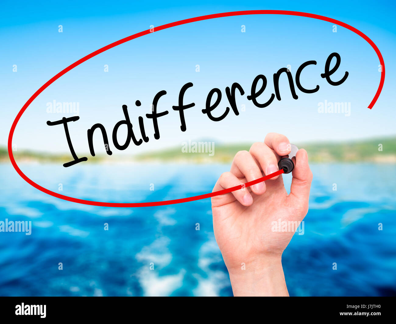 Man Hand writing Indifference with black marker on visual screen ...