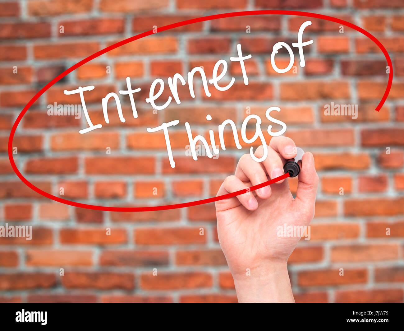 Man Hand writing Internet of Things with black marker on visual screen ...
