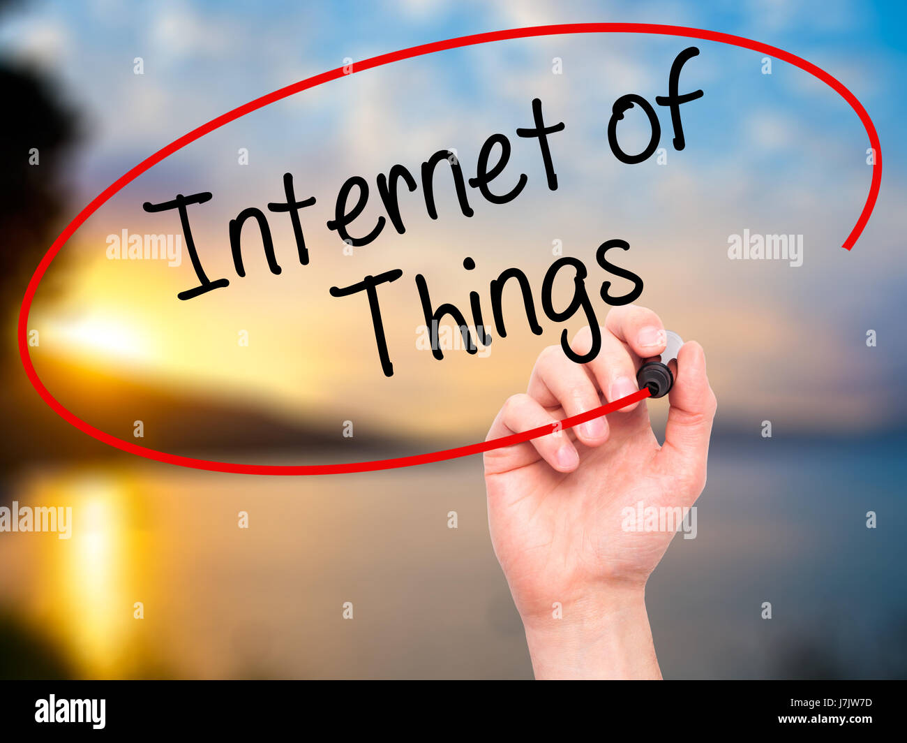Man Hand writing Internet of Things with black marker on visual screen ...