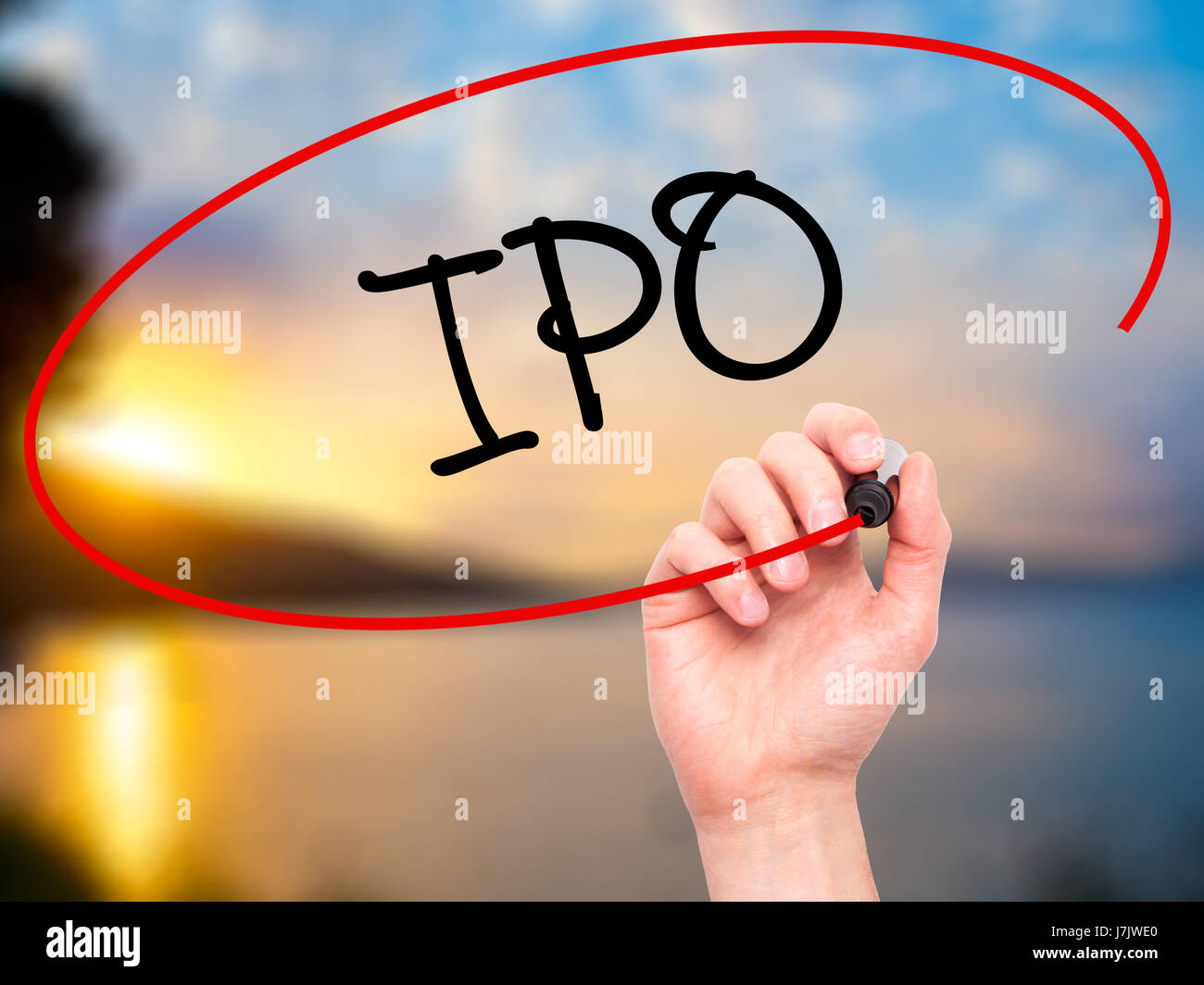 Man Hand writing IPO (Initial Public Offering) with black marker on ...