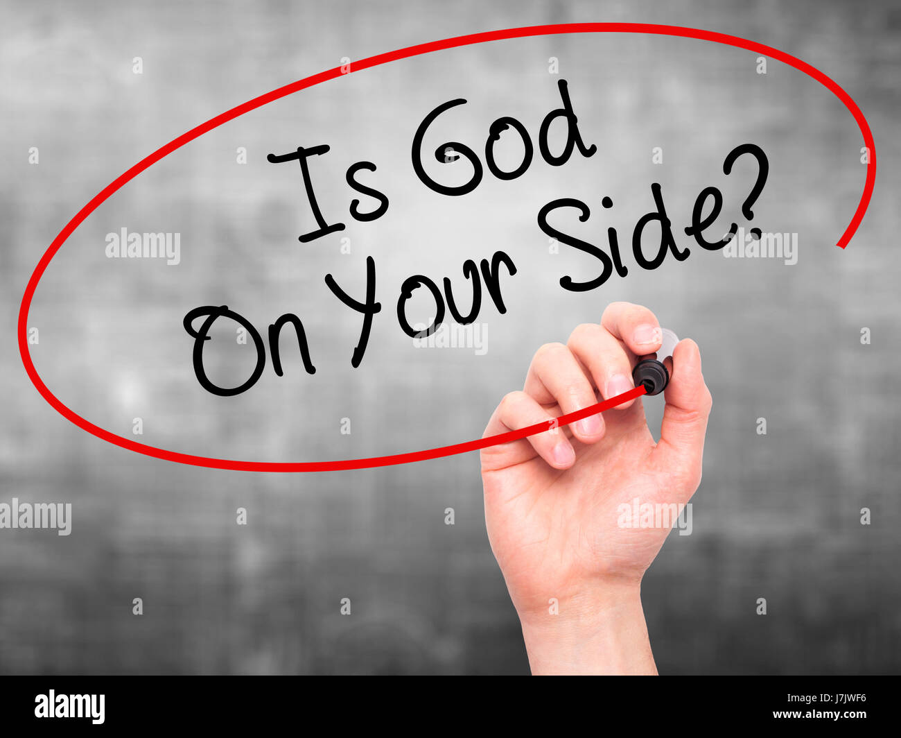 Man Hand writing Is God On Your Side? with marker on visual screen ...