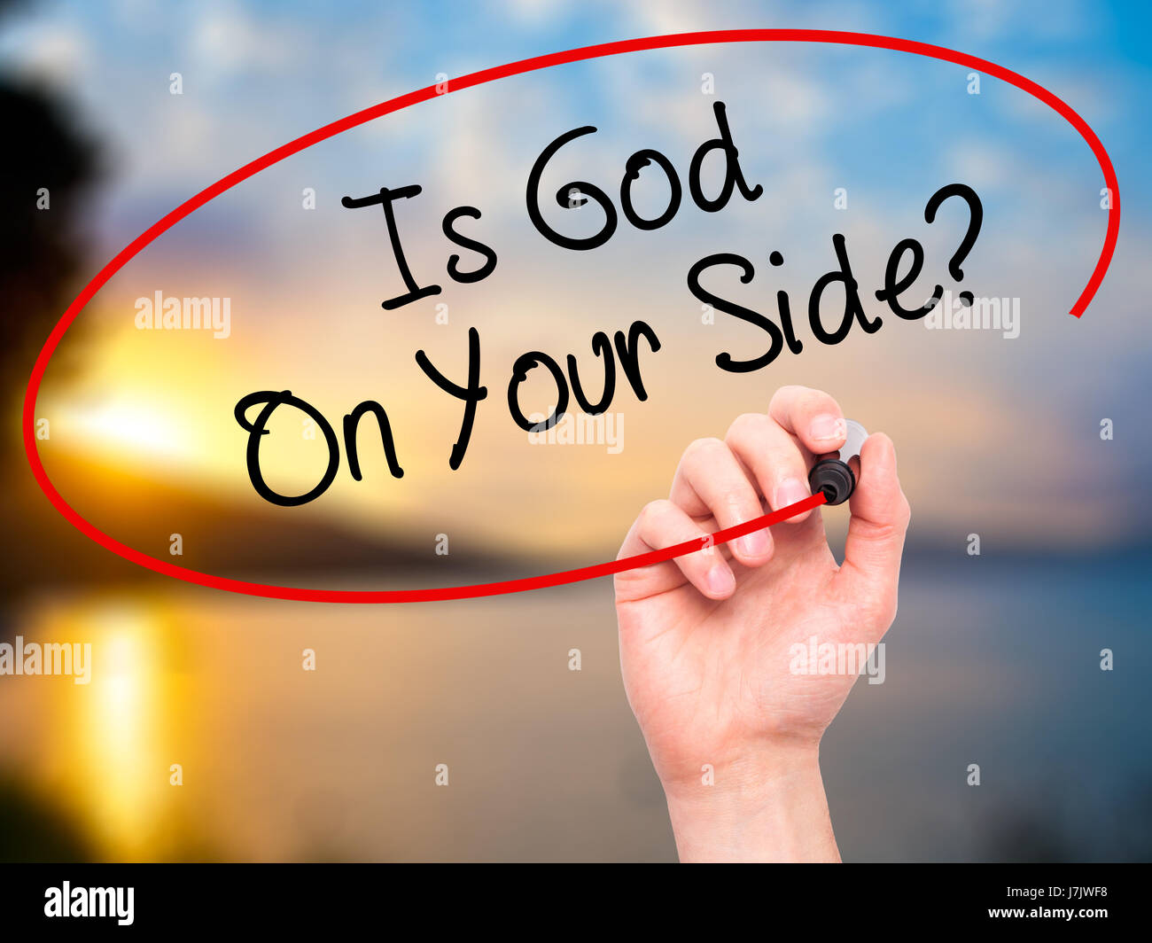 Man Hand writing Is God On Your Side? with marker on visual screen ...