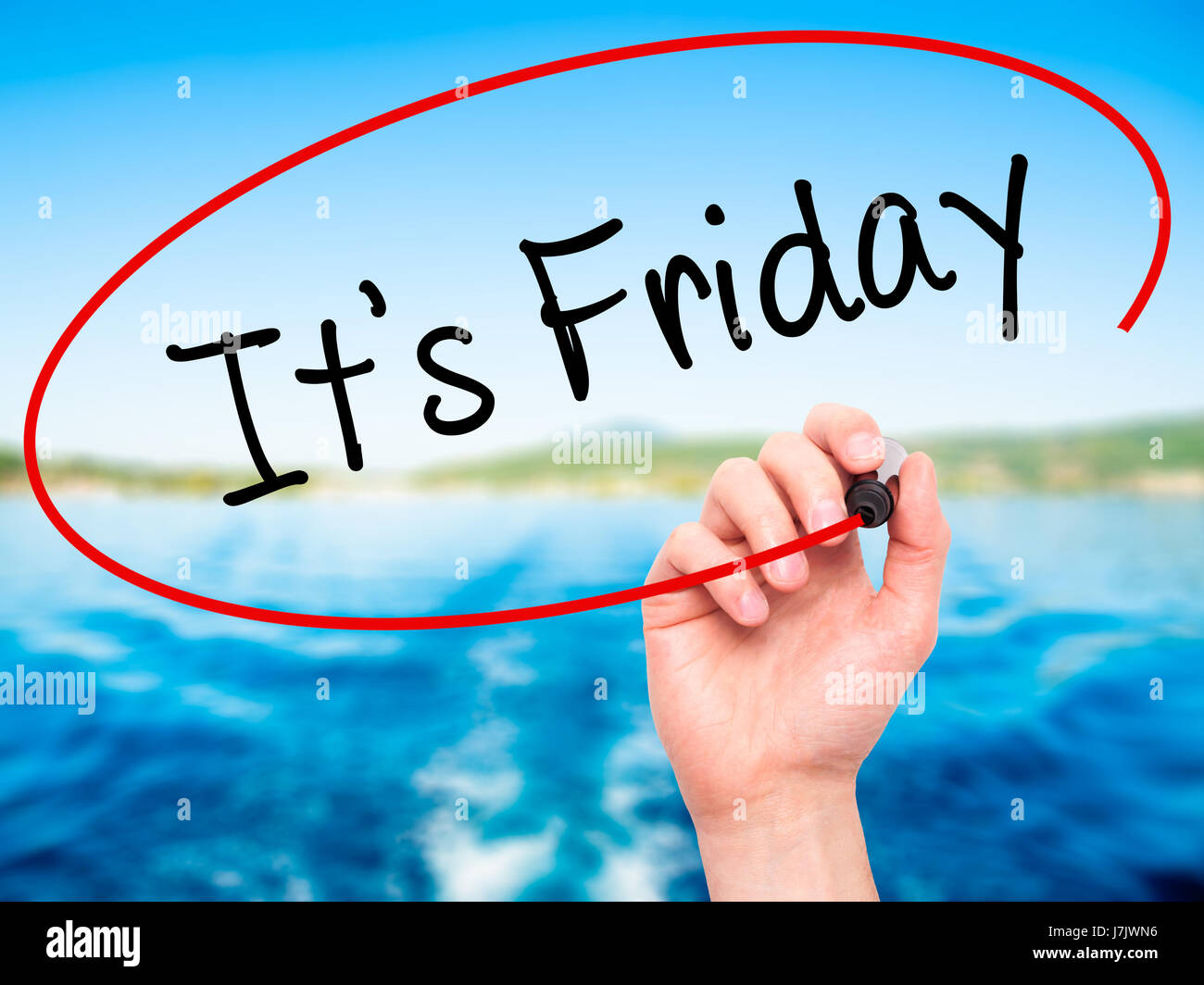 Man Hand writing It's Friday with black marker on visual screen ...