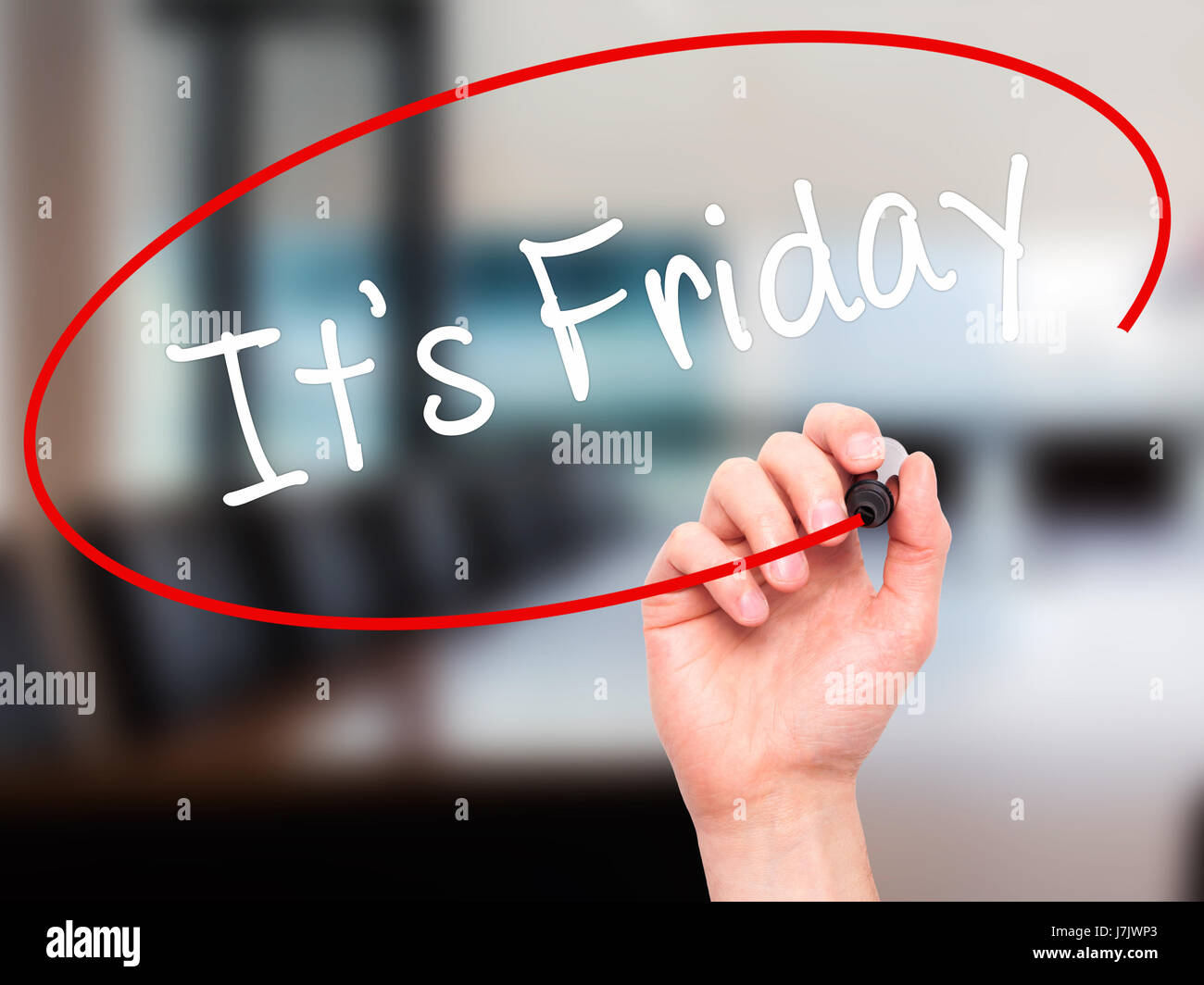 Man Hand writing It's Friday with black marker on visual screen ...