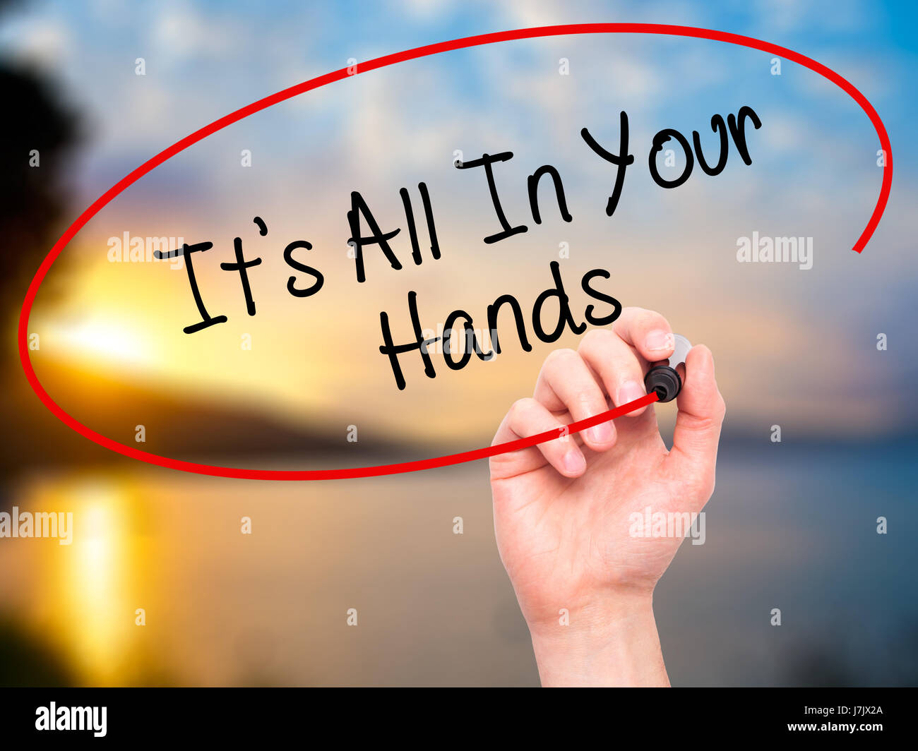 Man Hand writing It's All In Your Hands with black marker on visual ...