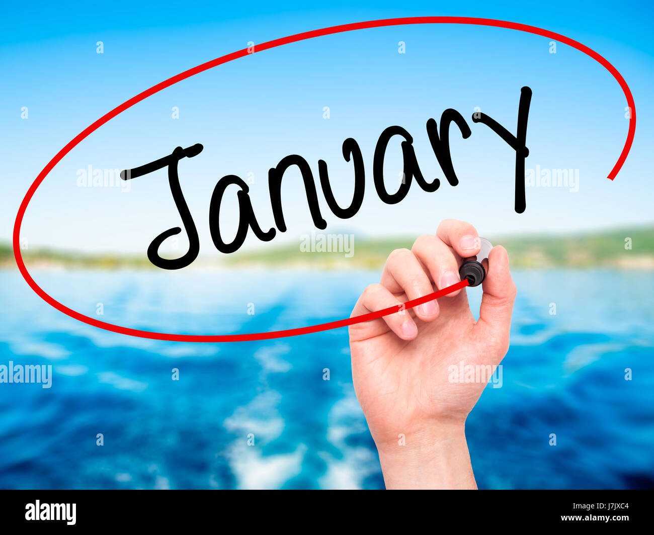 Man Hand writing January with black marker on visual screen. Isolated ...