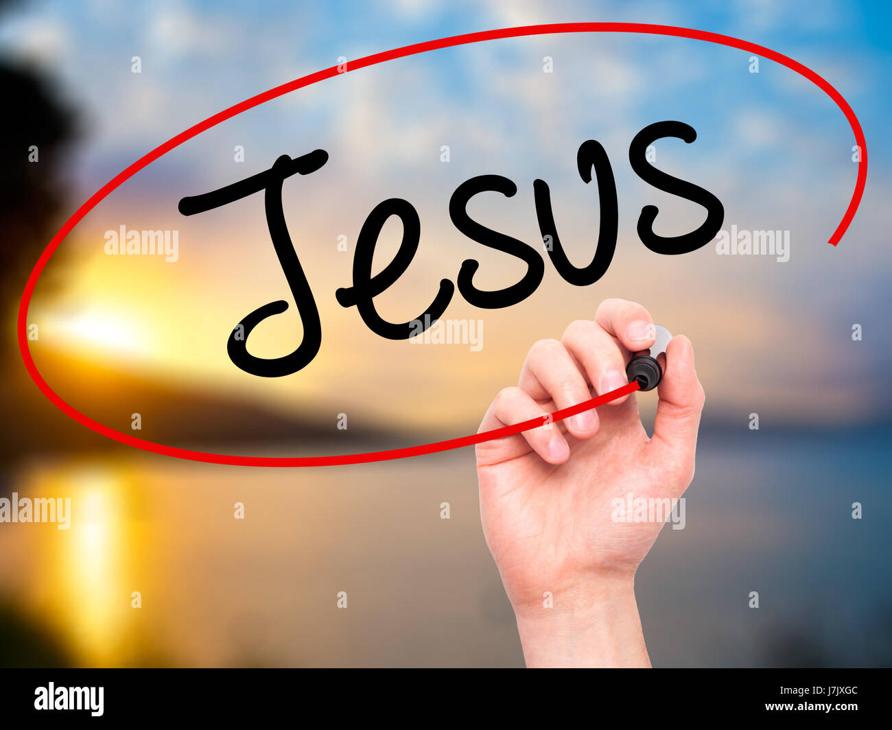 Man Hand writing Jesus with black marker on visual screen. Isolated on ...