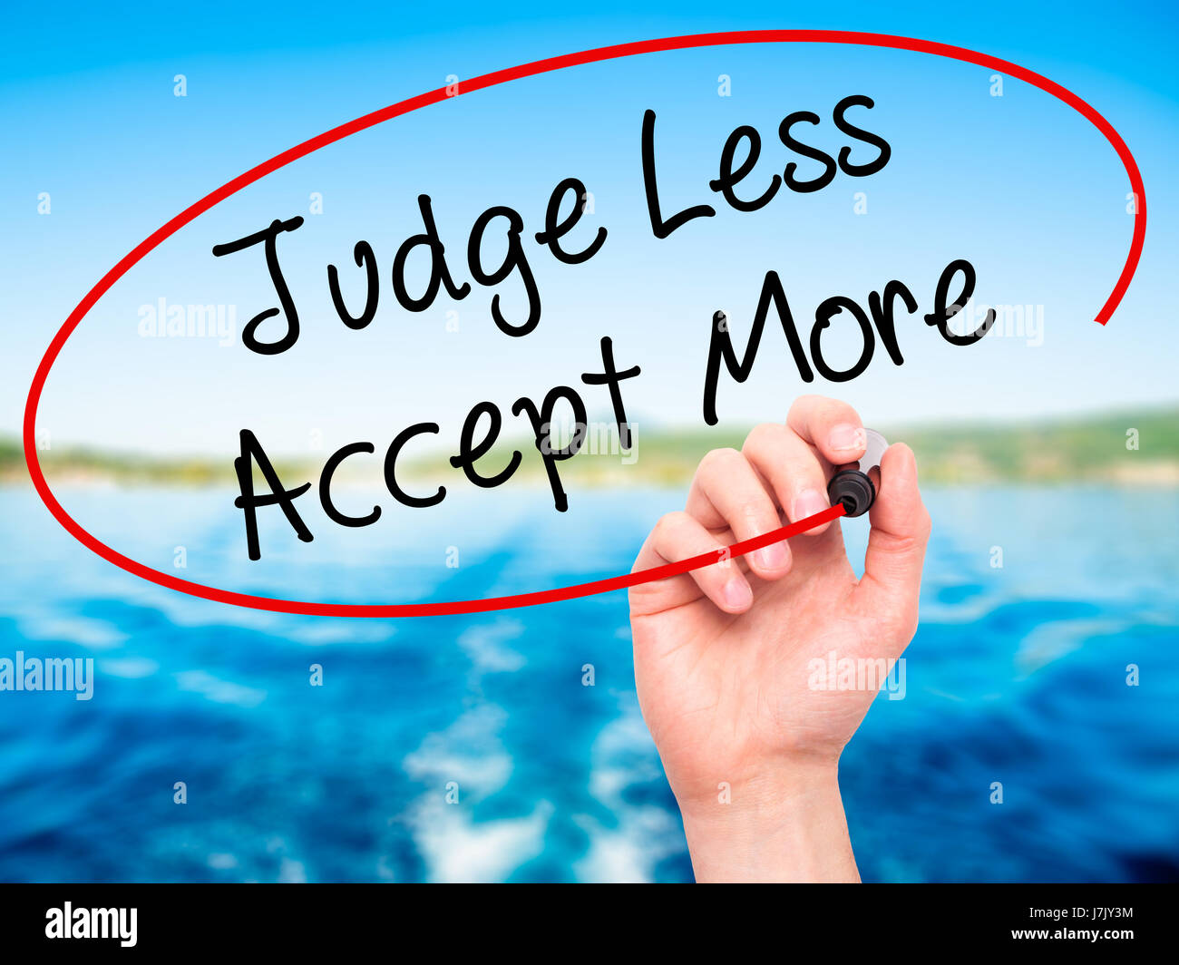 Man Hand writing Judge Less Accept More with black marker on visual ...