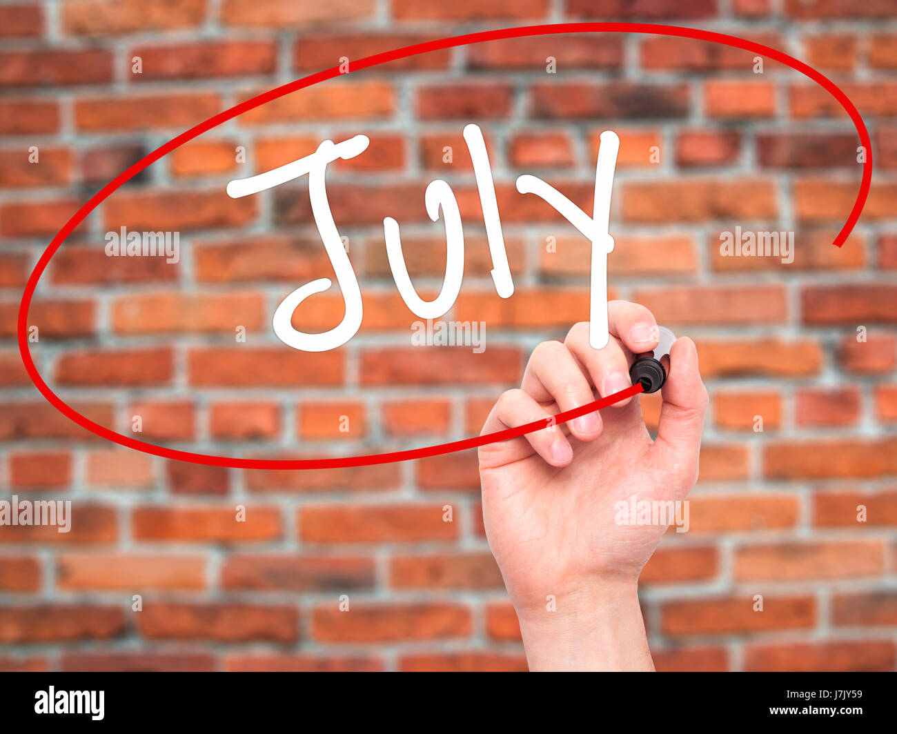 Man Hand writing July with black marker on visual screen. Isolated on ...