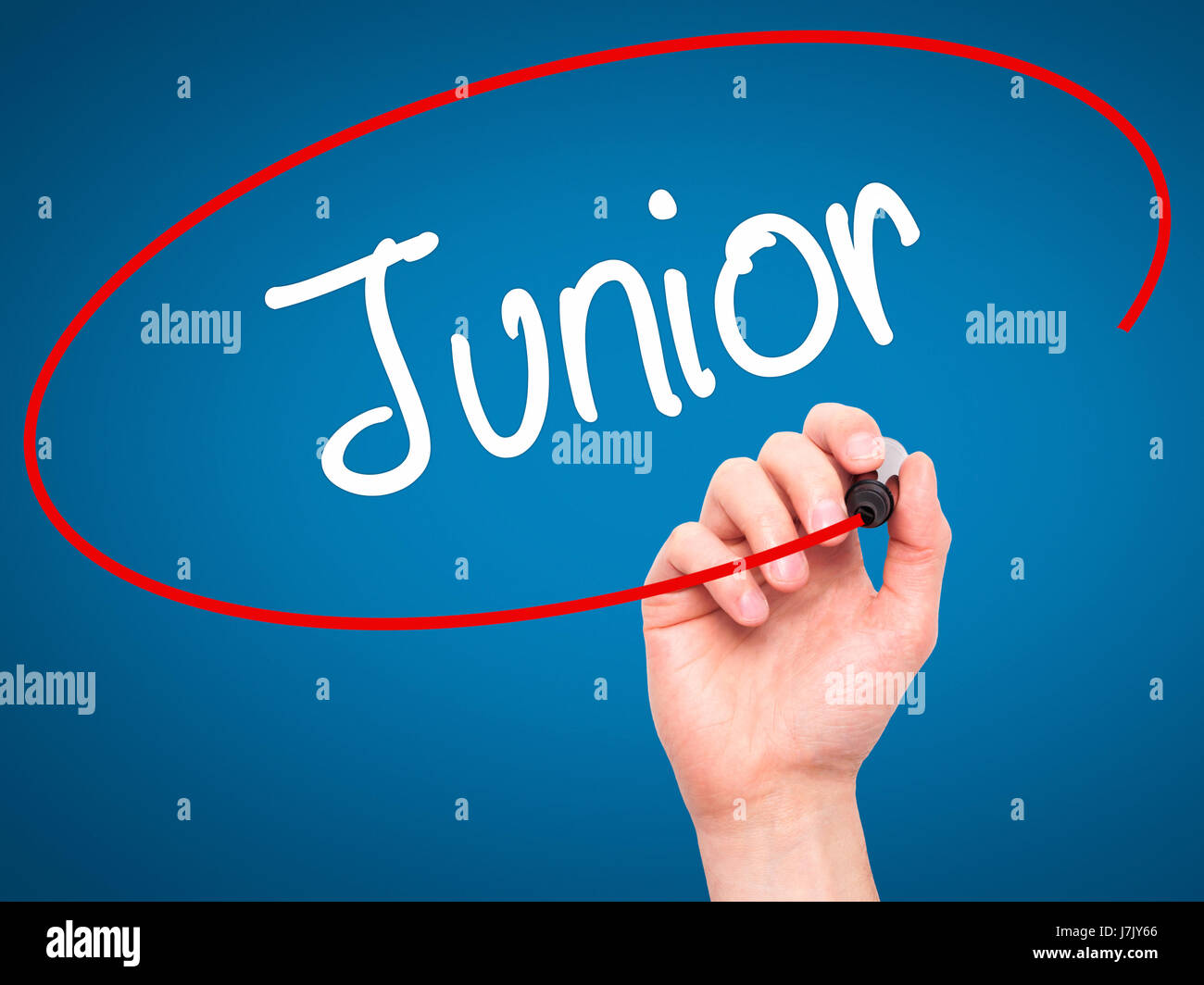 Man Hand writing Junior with black marker on visual screen. Isolated on ...