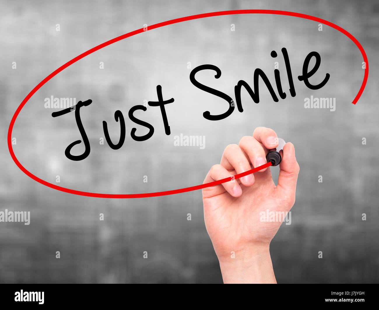 Man Hand writing Just Smile with black marker on visual screen ...