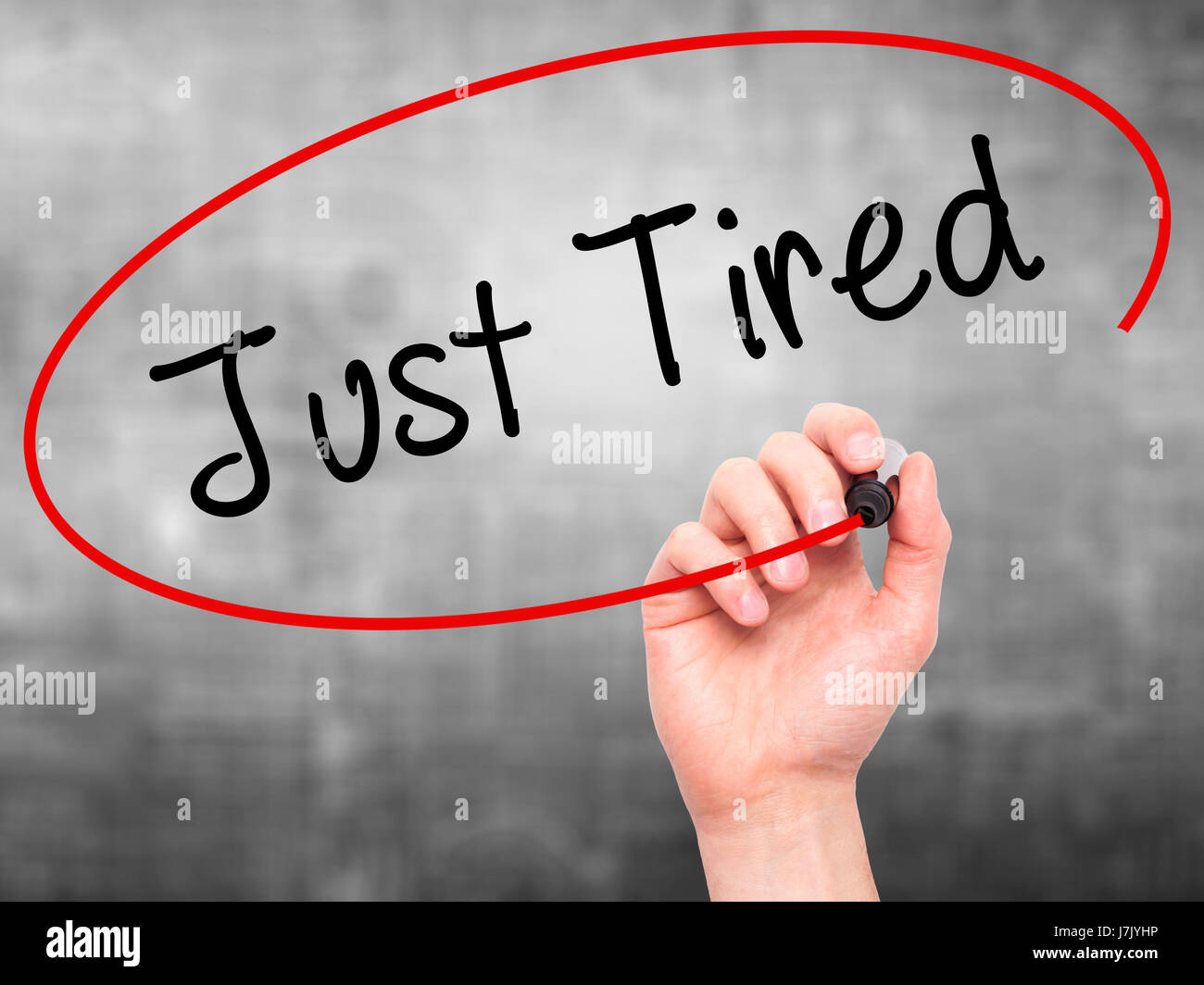 Man Hand writing Just Tired with black marker on visual screen ...