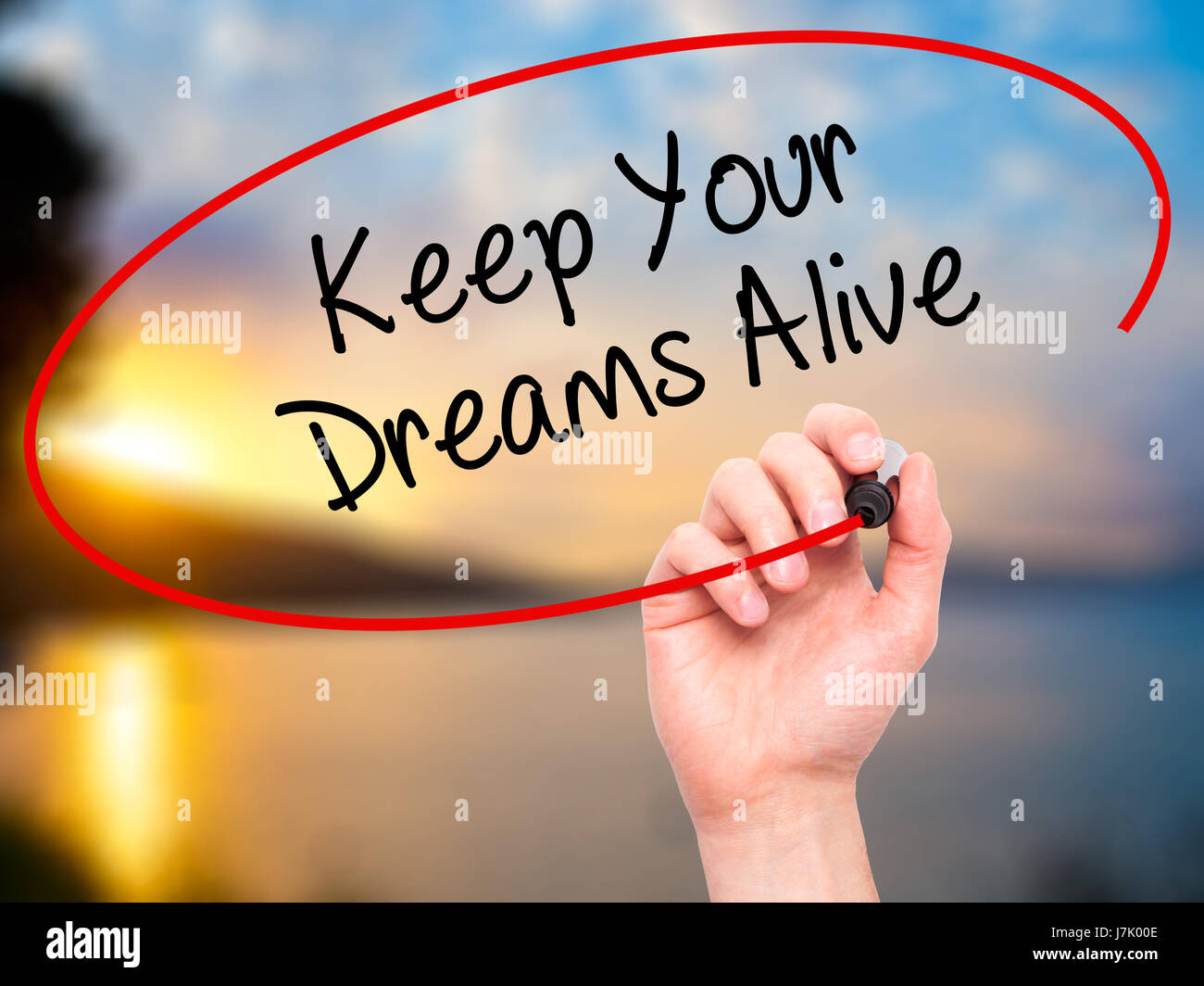 Man Hand writing Keep Your Dreams Alive with black marker on visual ...