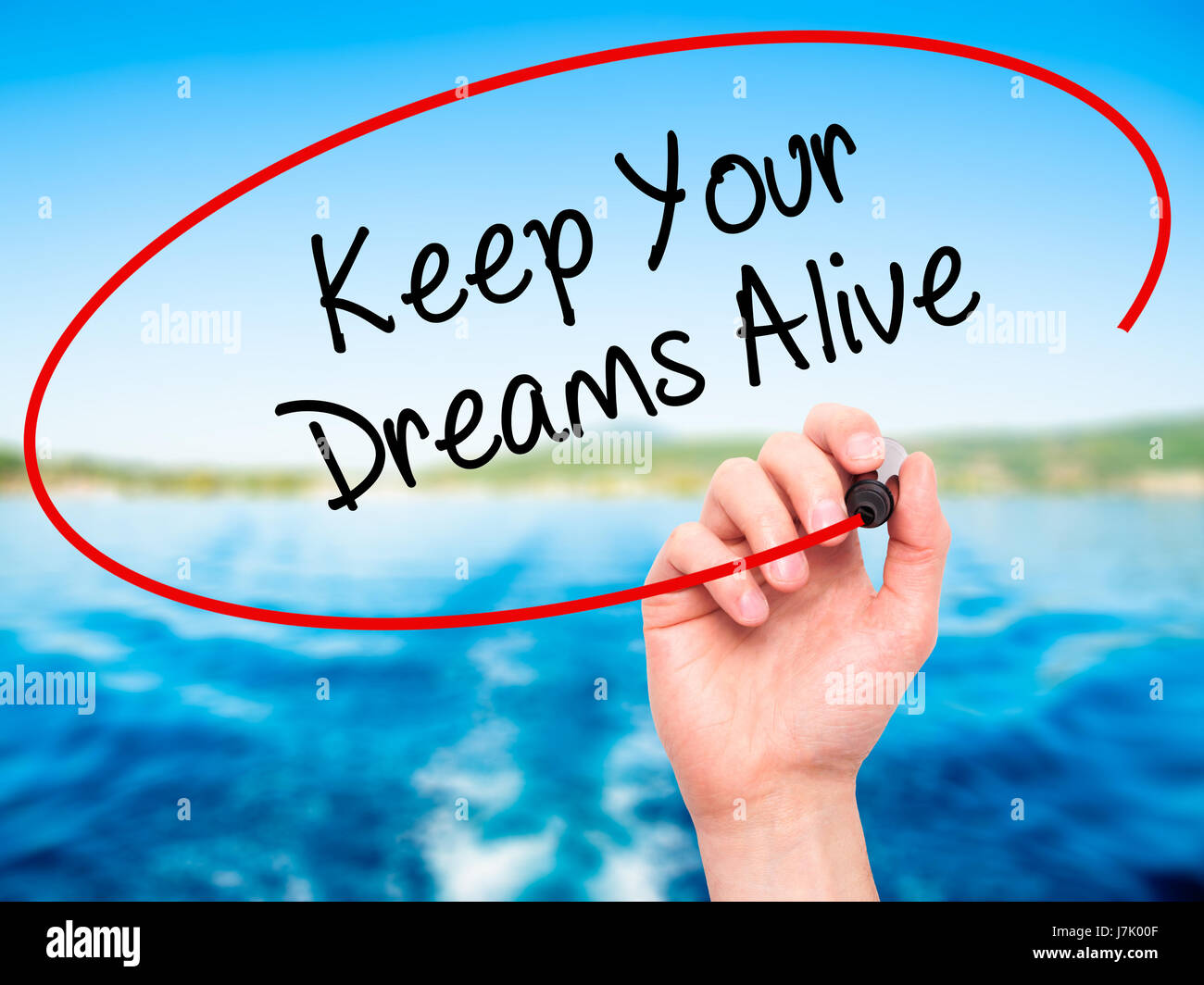 Man Hand writing Keep Your Dreams Alive with black marker on visual ...