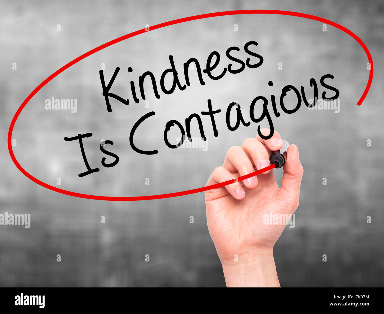 Man Hand writing Kindness Is Contagious with black marker on visual ...