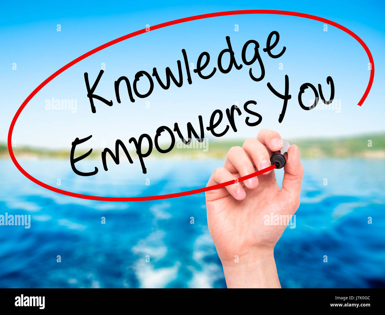 Man Hand writing Knowledge Empowers You with black marker on visual ...