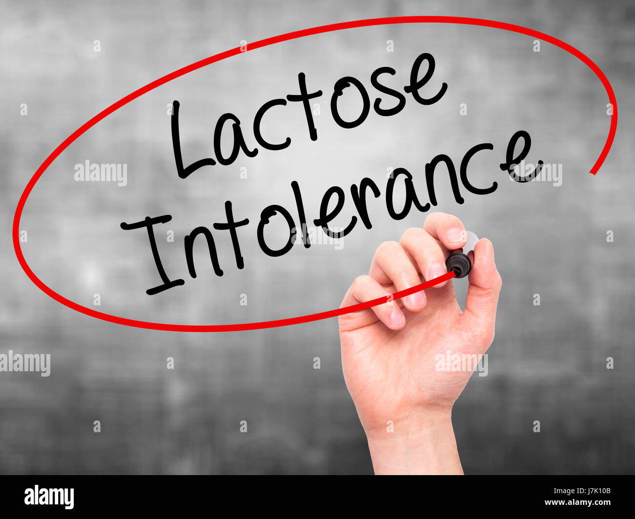 Man Hand writing Lactose Intolerance with black marker on visual screen ...