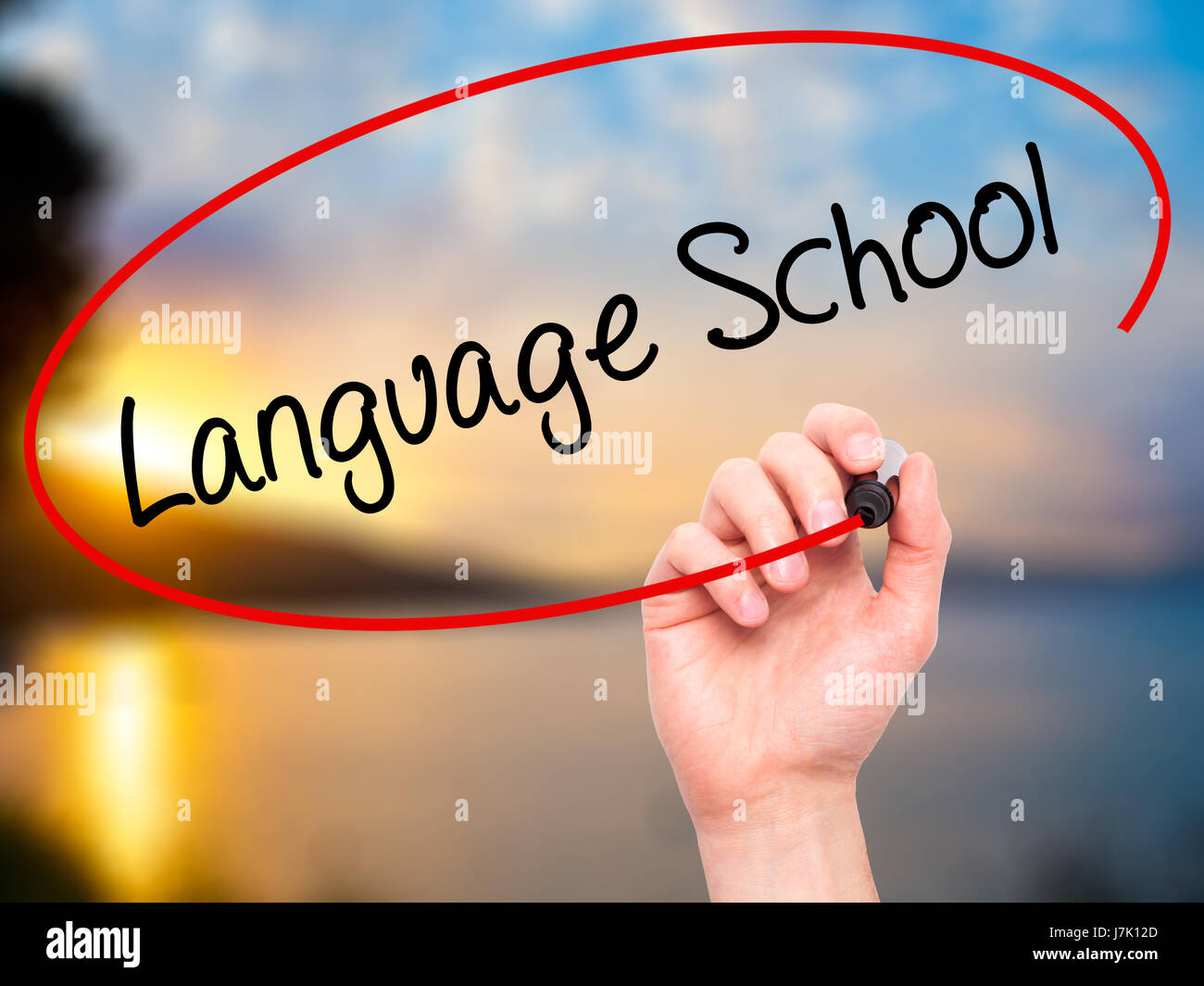Man Hand writing Language School with black marker on visual screen ...